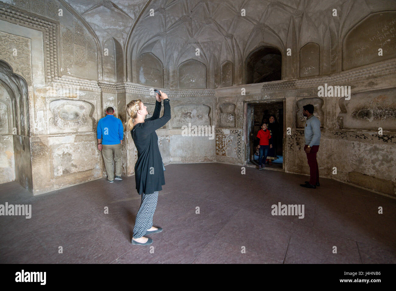 Tourist photographing the interior of the Agra Fort, located in Agra ...
