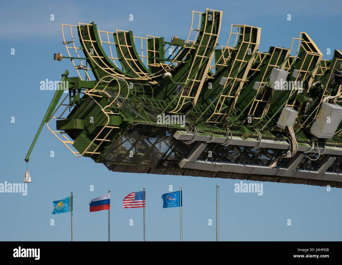 A gantry arm closes around the Soyuz MS-04 spacecraft rocket to secure ...