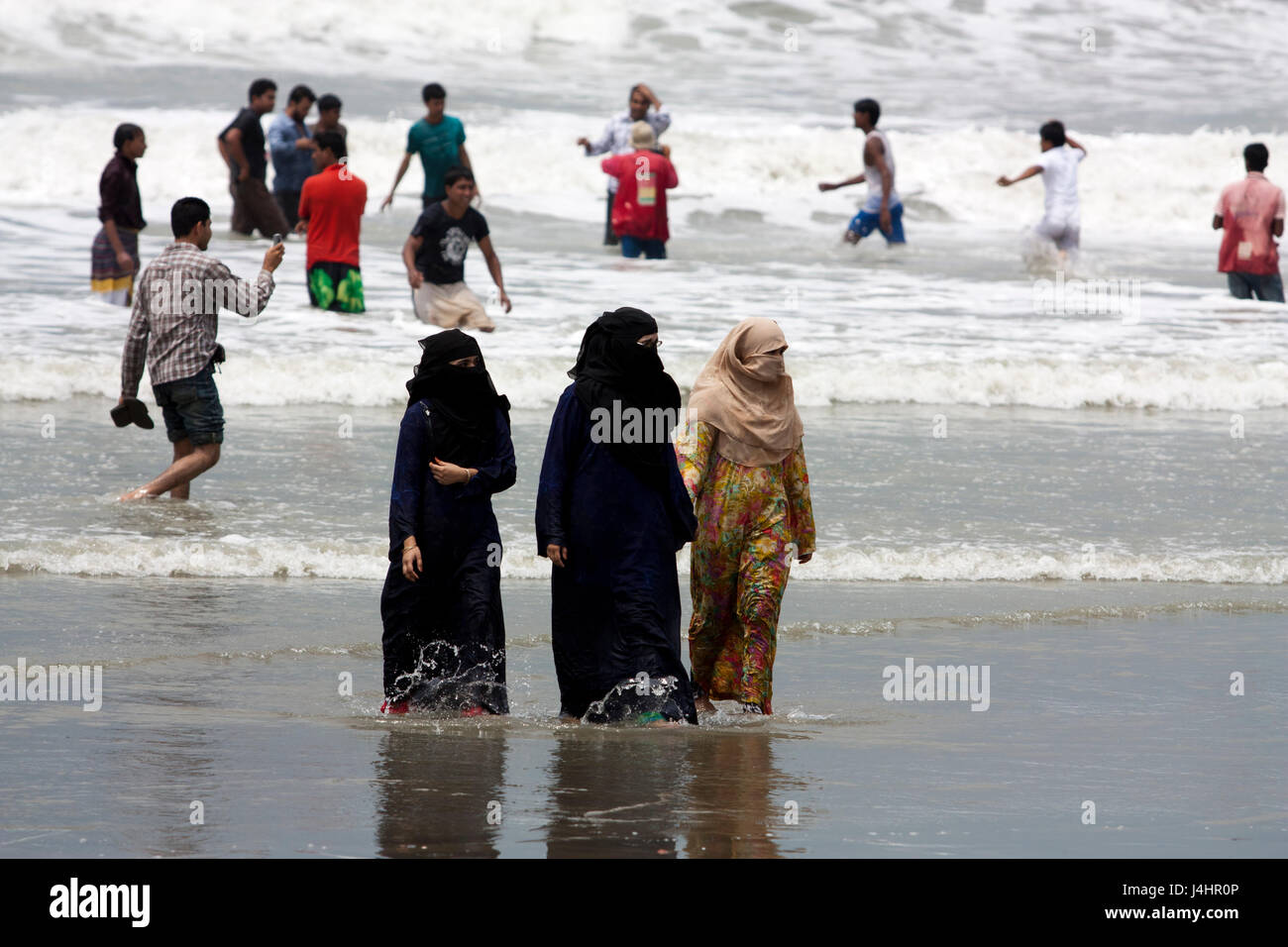 Tourists bathe on the Bay of Bengal at the Cox’s Bazar sea beach. It is ...