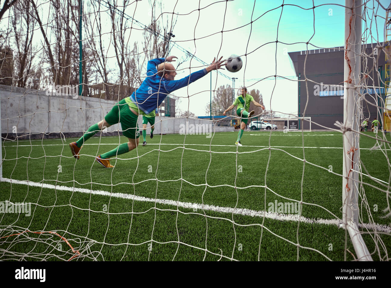 Soccer football goalkeeper making diving save Stock Photo - Alamy