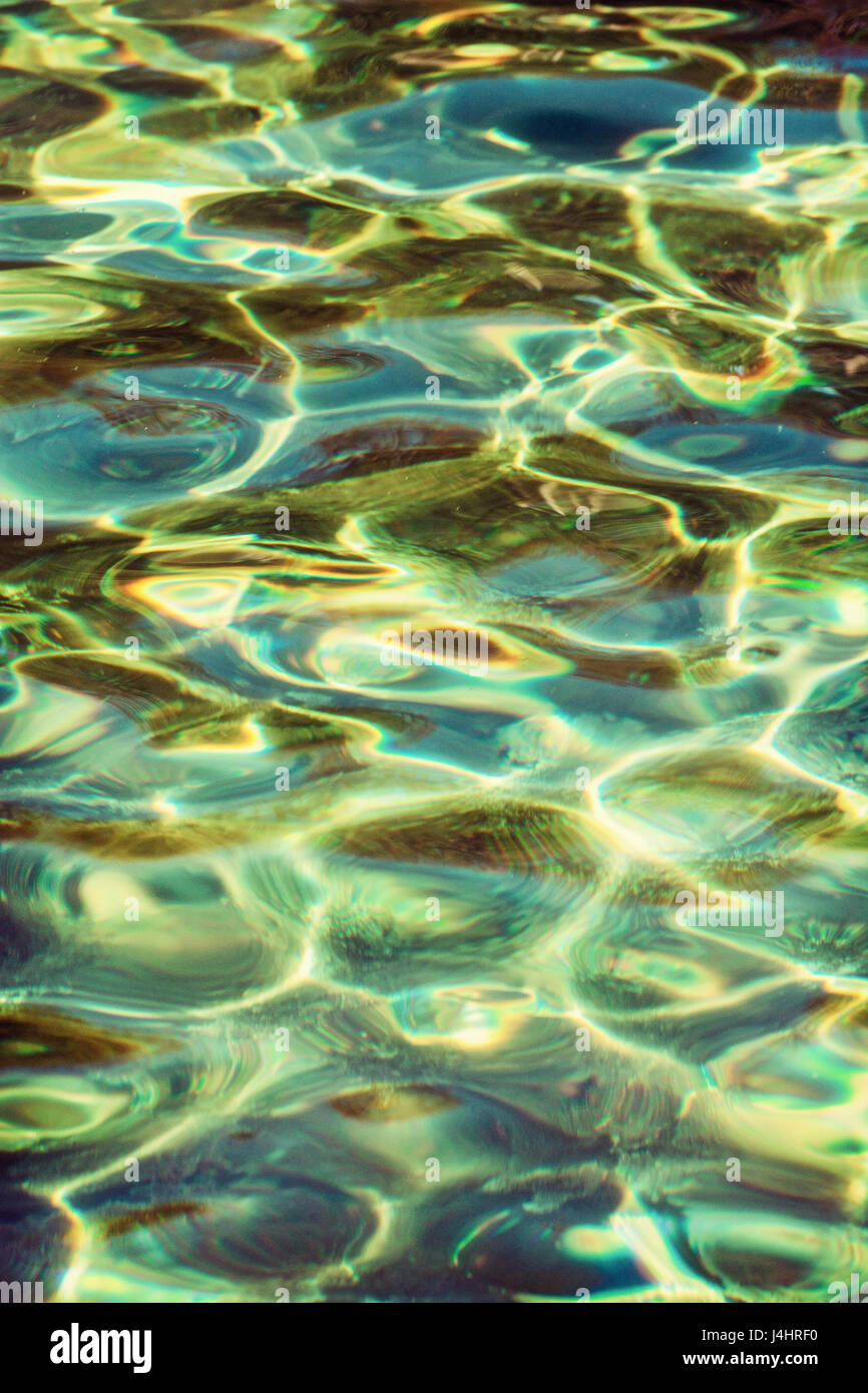 Rippled water surface with natural reflections. Yellow photo filter ...
