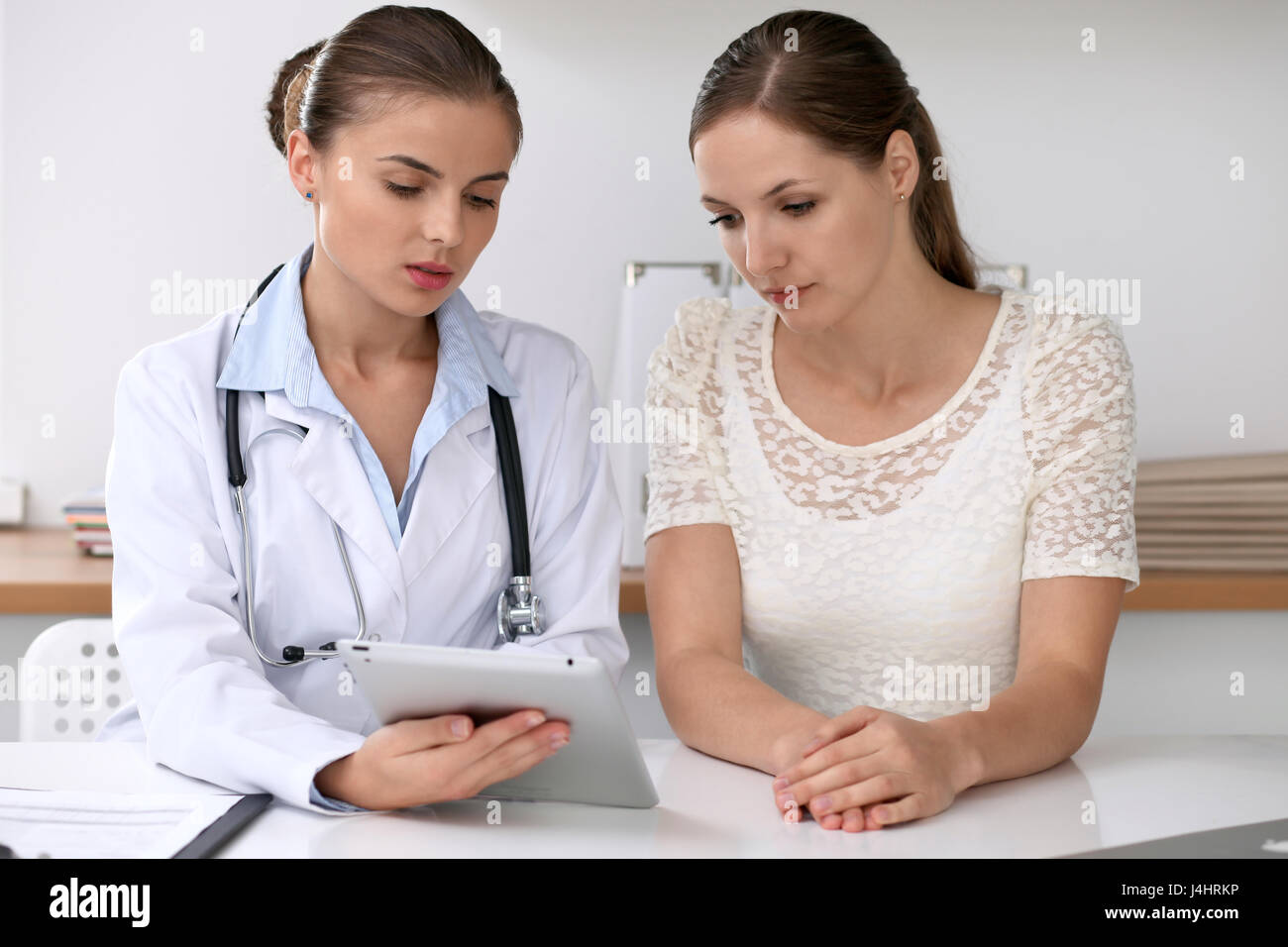 Doctor and patient sitting at the desk. Medicine and health care ...