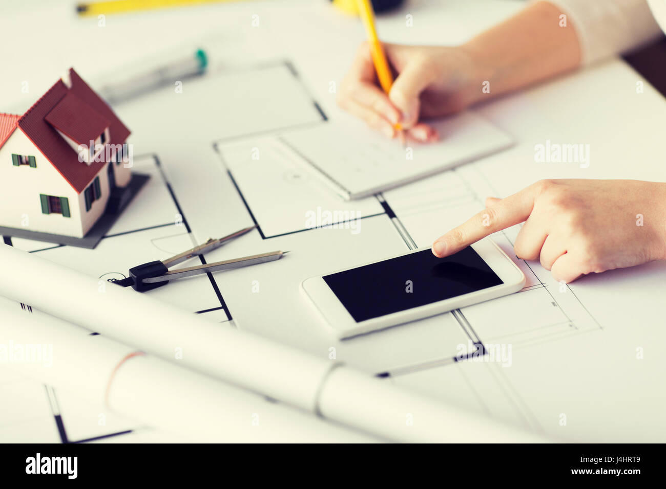 close up of hands with blueprint and smarphone Stock Photo - Alamy