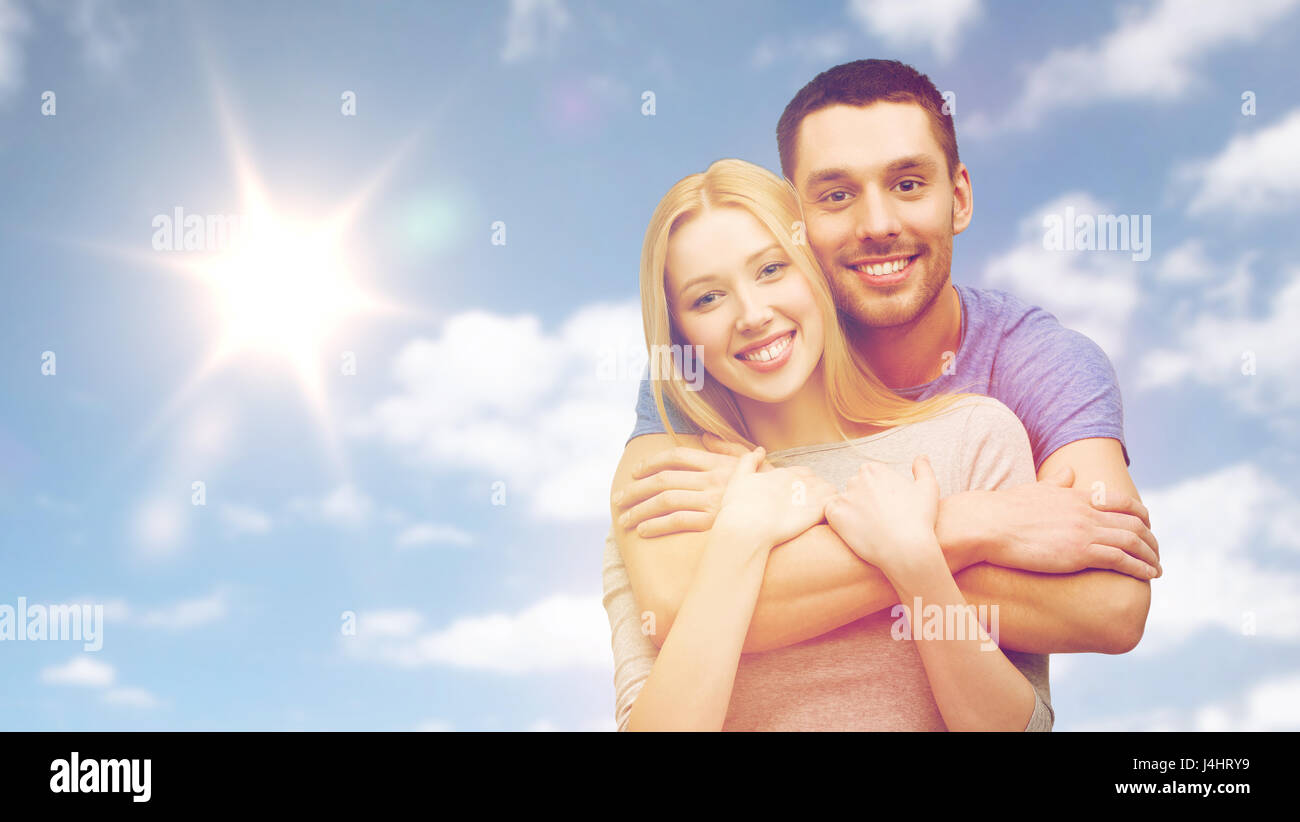 happy smiling couple hugging over sky and sun Stock Photo - Alamy