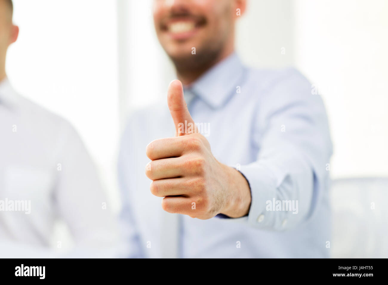 hand of smiling businessman showing thumbs up Stock Photo - Alamy