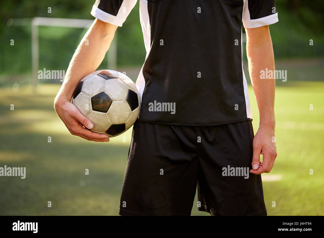 soccer player with ball on football field Stock Photo - Alamy