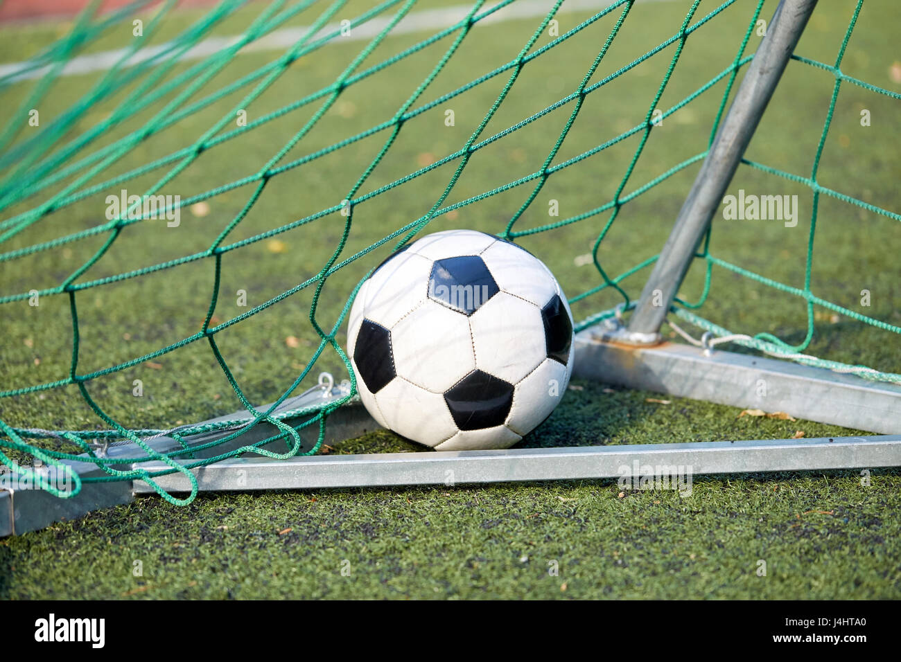 soccer ball at goal net on football field Stock Photo - Alamy
