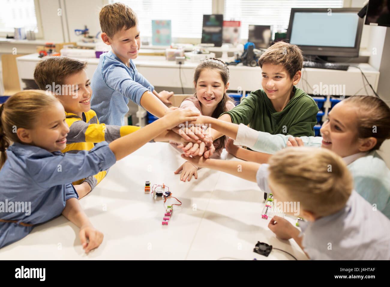 happy children holding hands at robotics school Stock Photo - Alamy