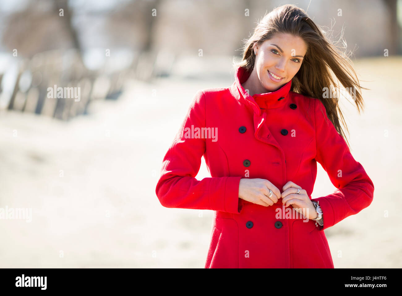 Young woman in red coat outdoor Stock Photo - Alamy