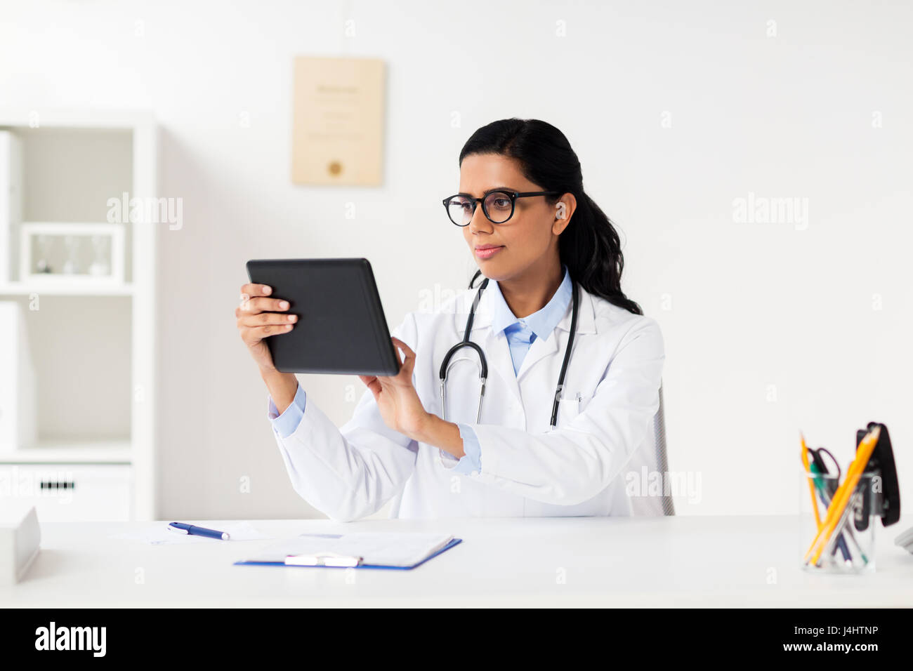 doctor with tablet pc and clipboard at hospital Stock Photo - Alamy