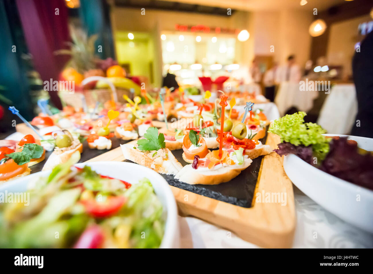 Beautifully decorated catering banquet table with different food snacks ...