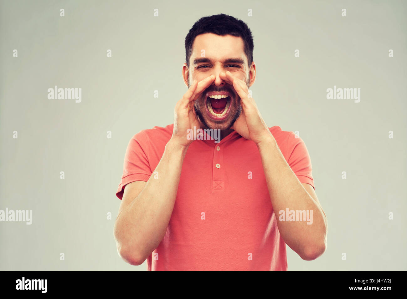 angry shouting man in t-shirt over gray background Stock Photo - Alamy
