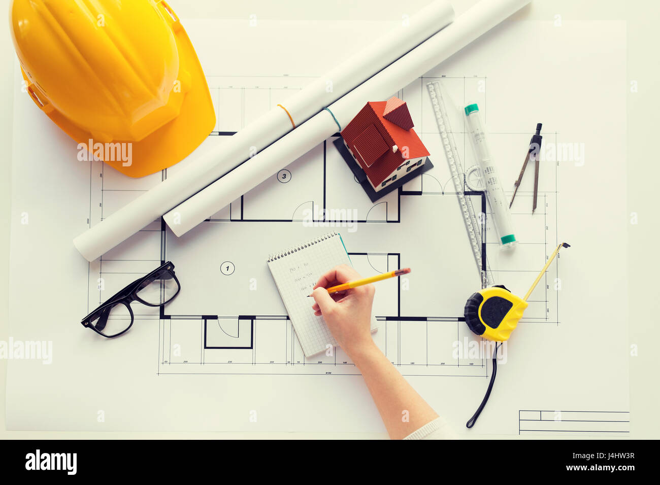close up of architect hand with blueprint Stock Photo - Alamy