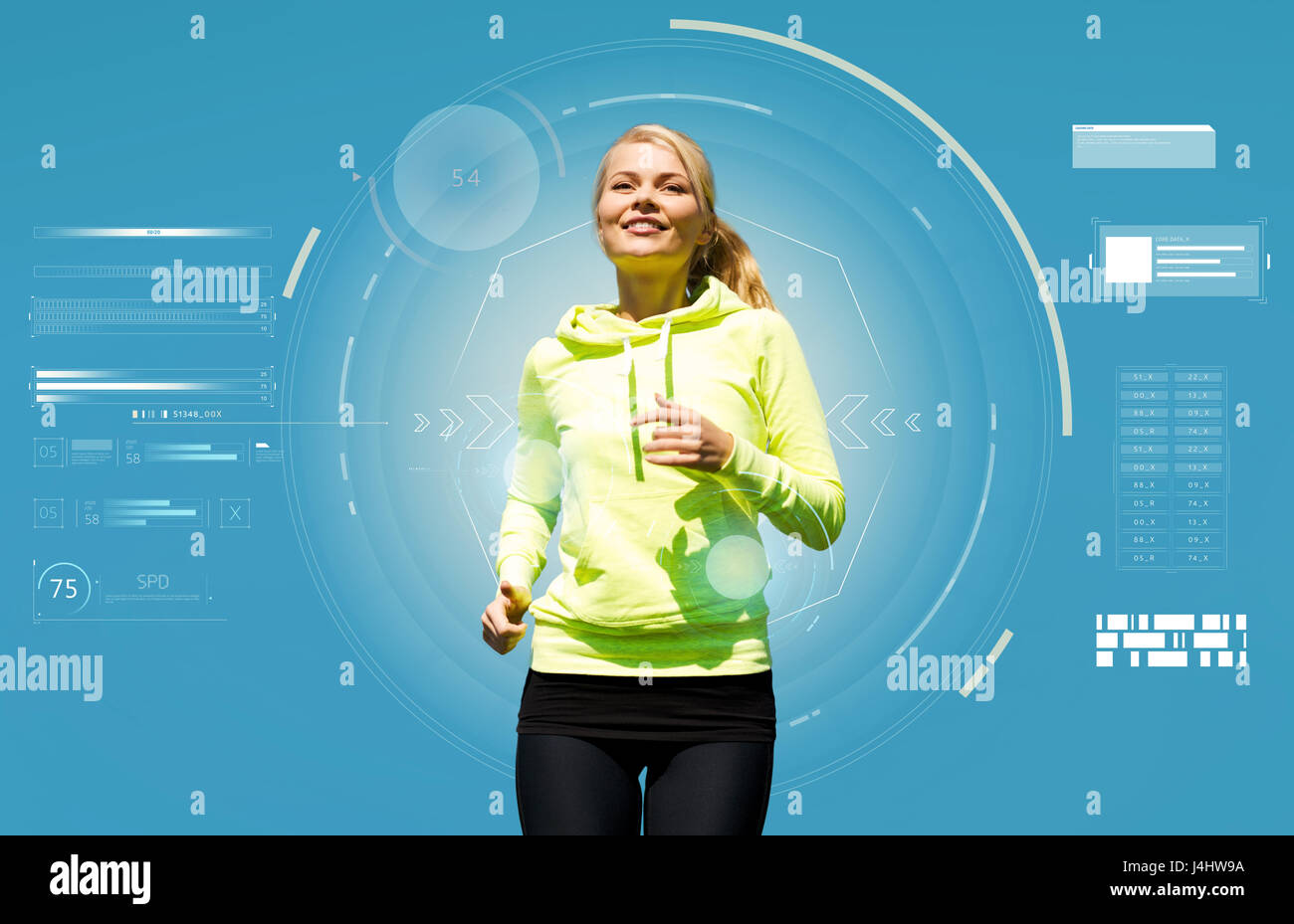 smiling young woman running over blue background Stock Photo - Alamy