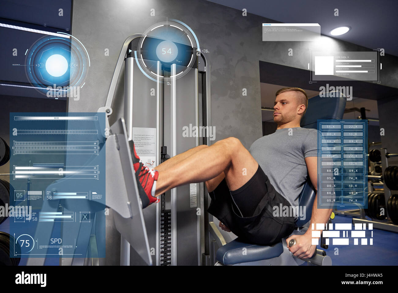 man flexing leg muscles on gym machine Stock Photo - Alamy