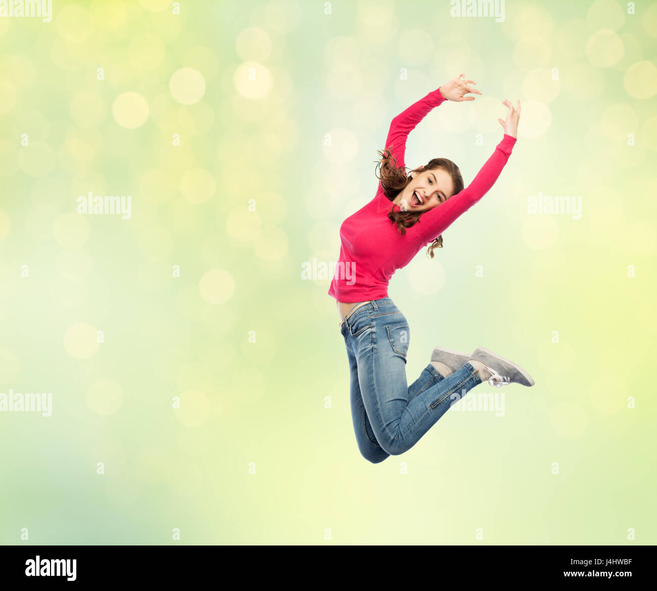 happy young woman jumping in air or dancing Stock Photo - Alamy