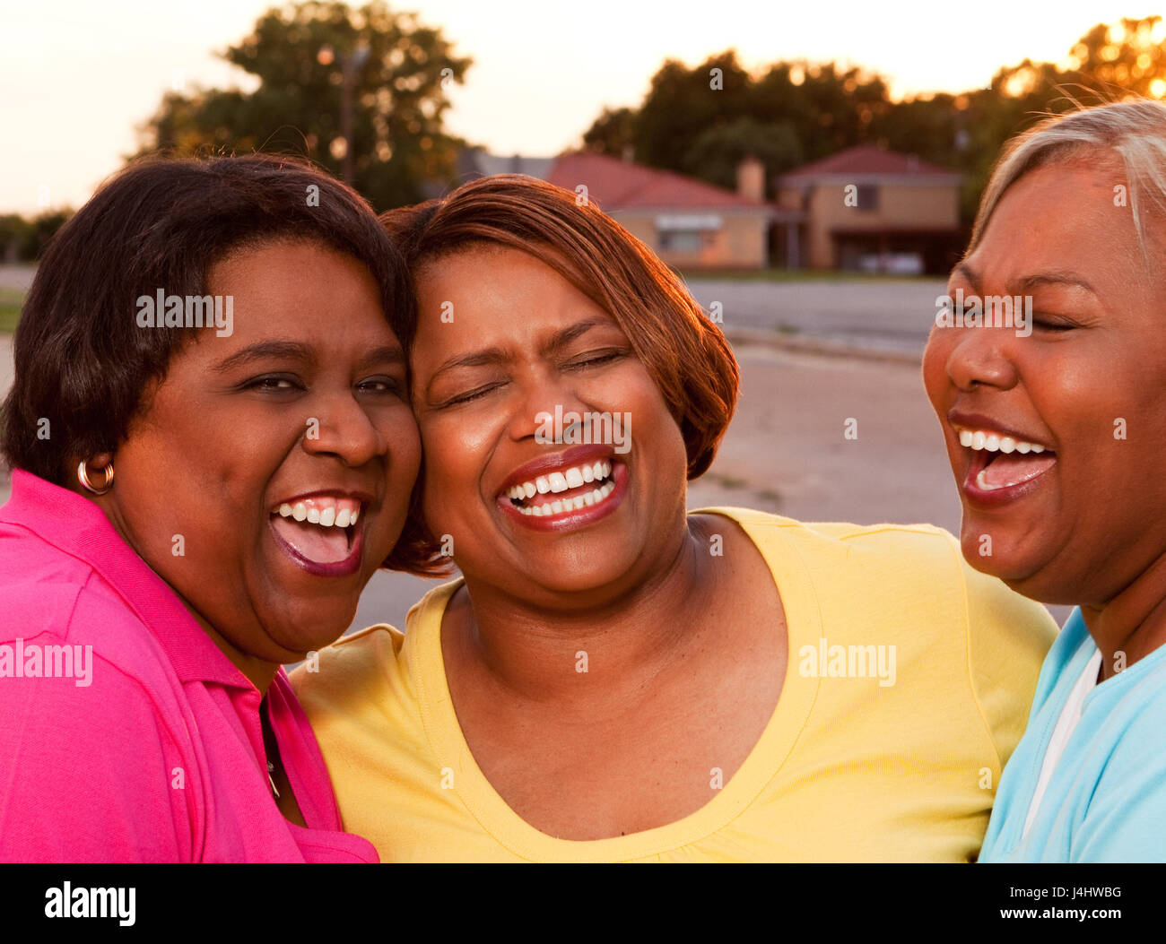 African Amrican woman talking and laughing outside Stock Photo - Alamy