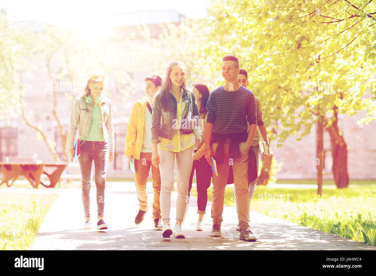 group of happy teenage students walking outdoors Stock Photo - Alamy