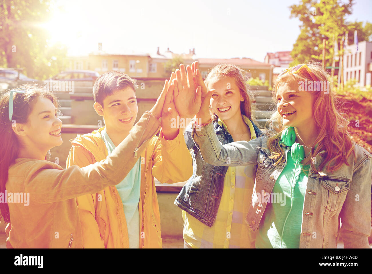 happy students or friends making high five Stock Photo - Alamy
