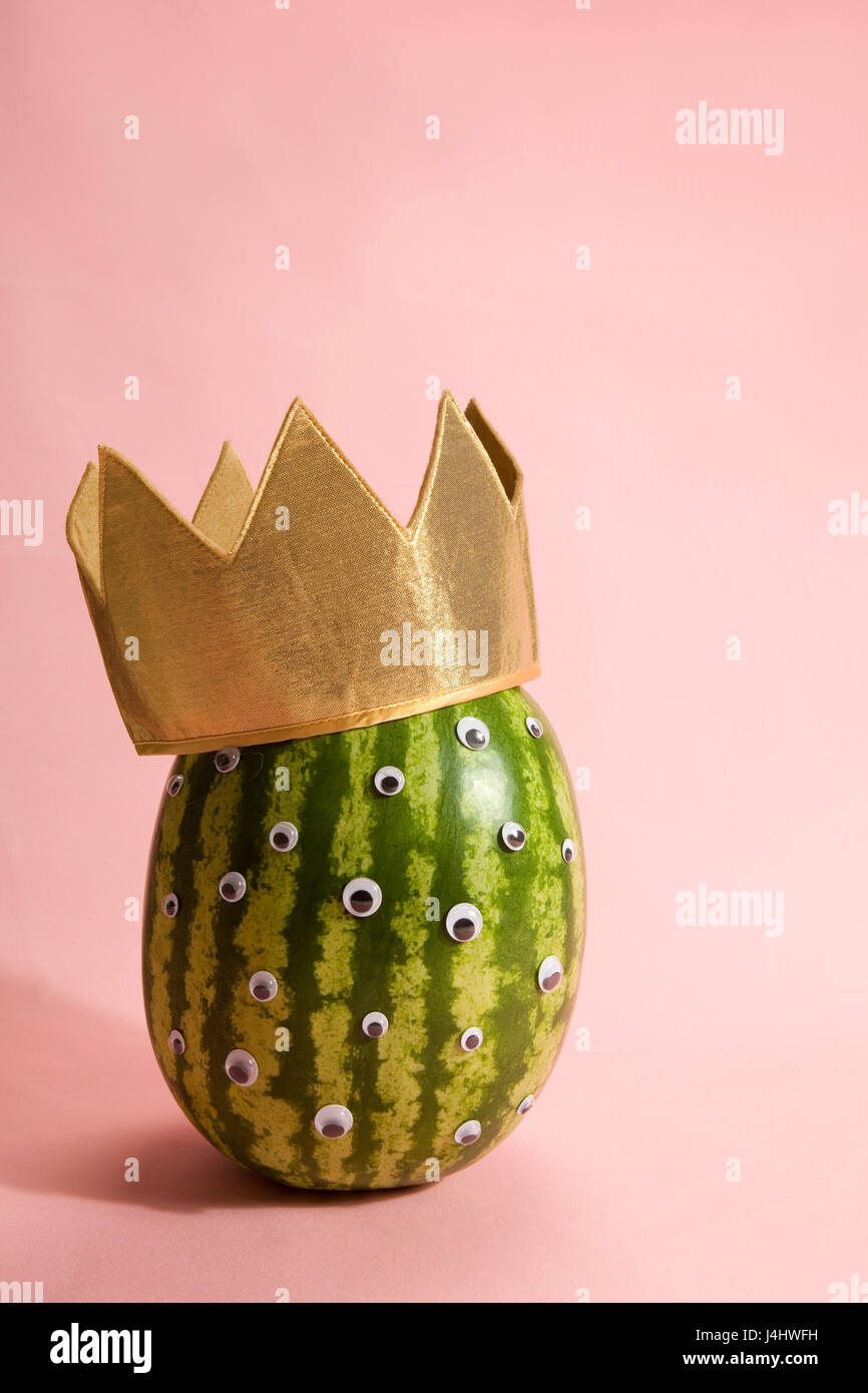 Freak watermelon wearing a crown on a pink background Stock Photo - Alamy
