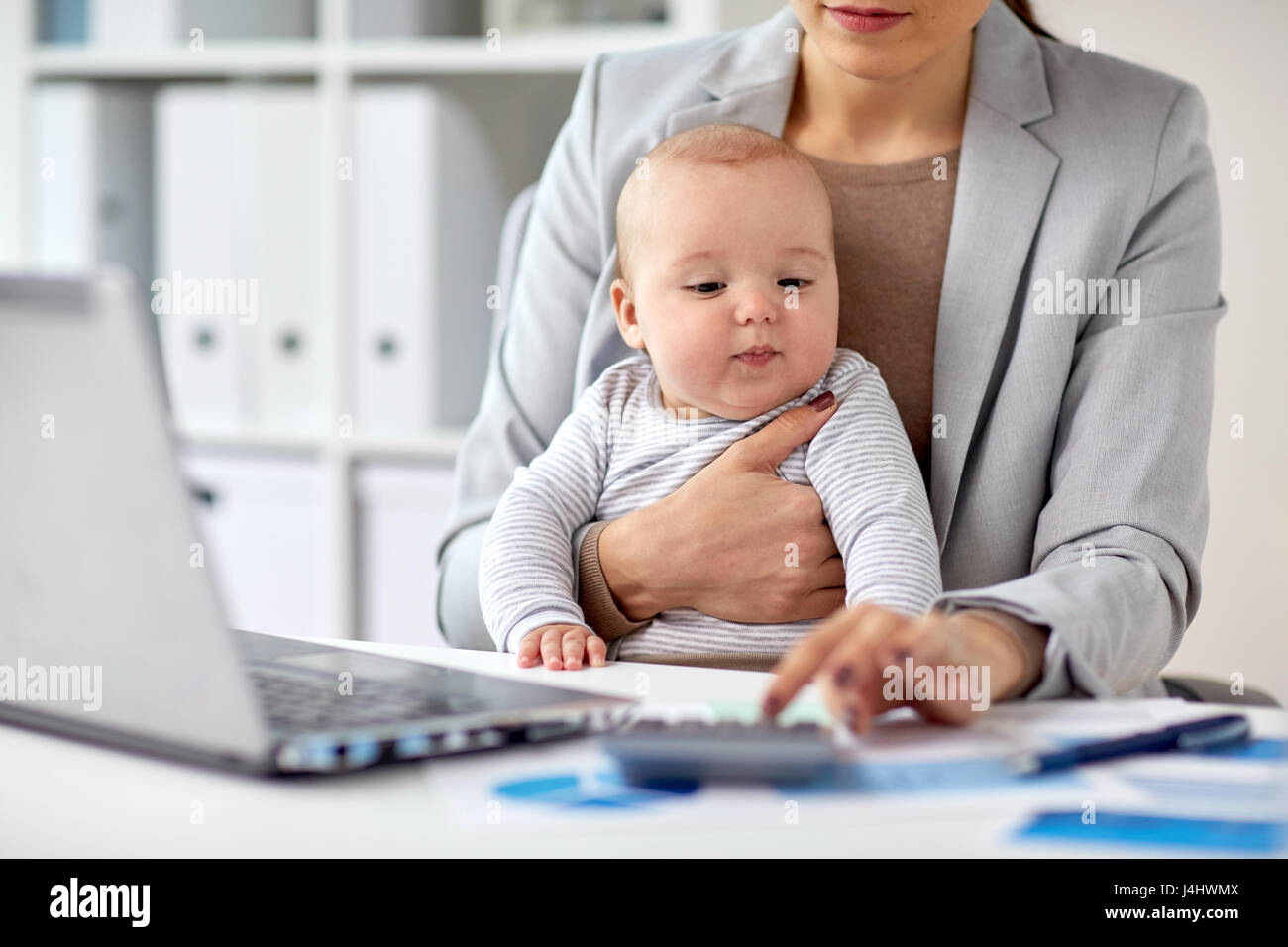 businesswoman with baby working at office Stock Photo - Alamy