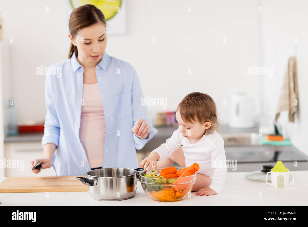 happy mother and baby cooking food at home kitchen Stock Photo - Alamy