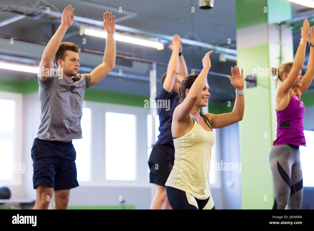 group of happy friends exercising in gym Stock Photo - Alamy