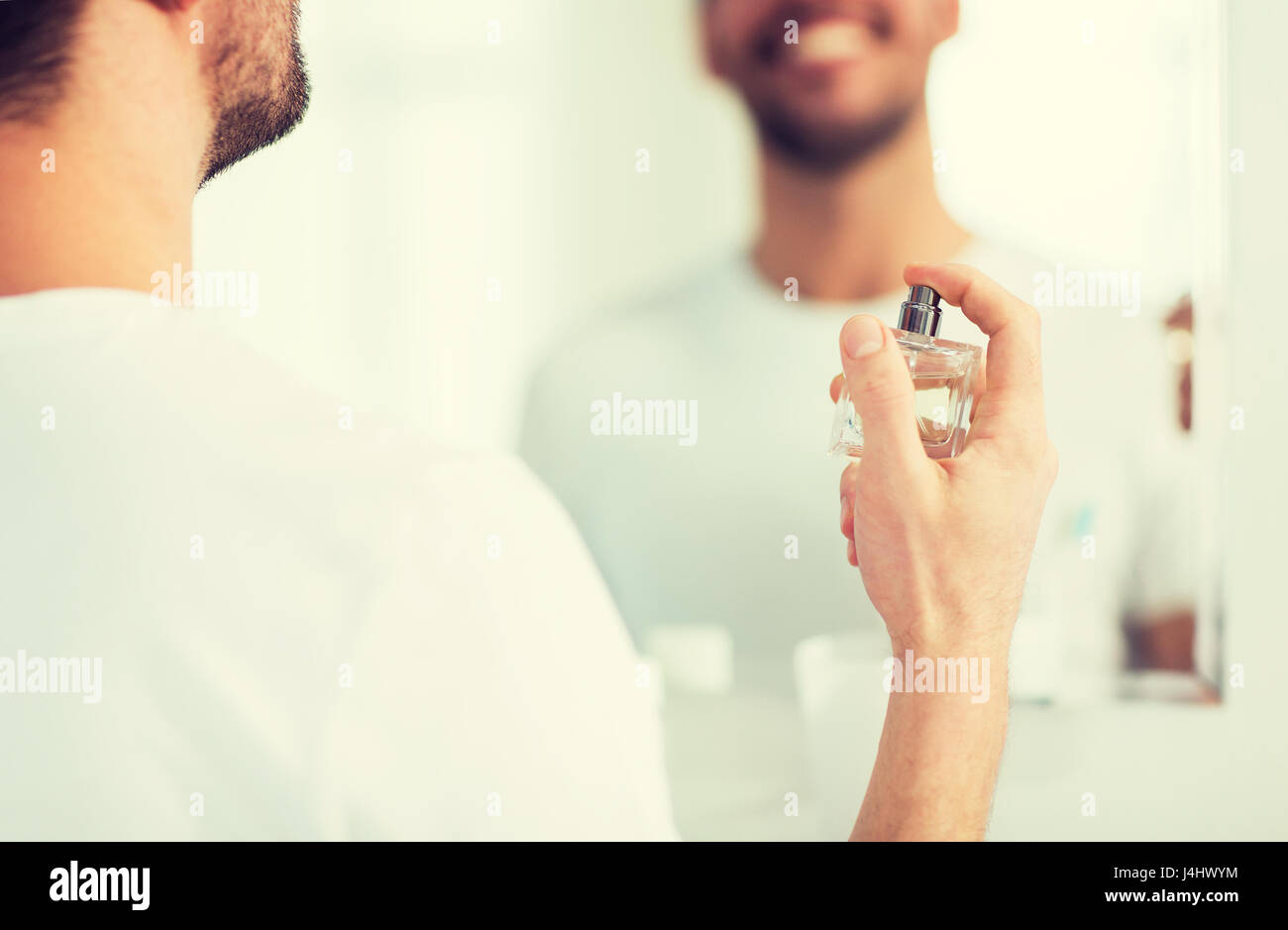 close up of man perfuming with perfume at bathroom Stock Photo - Alamy