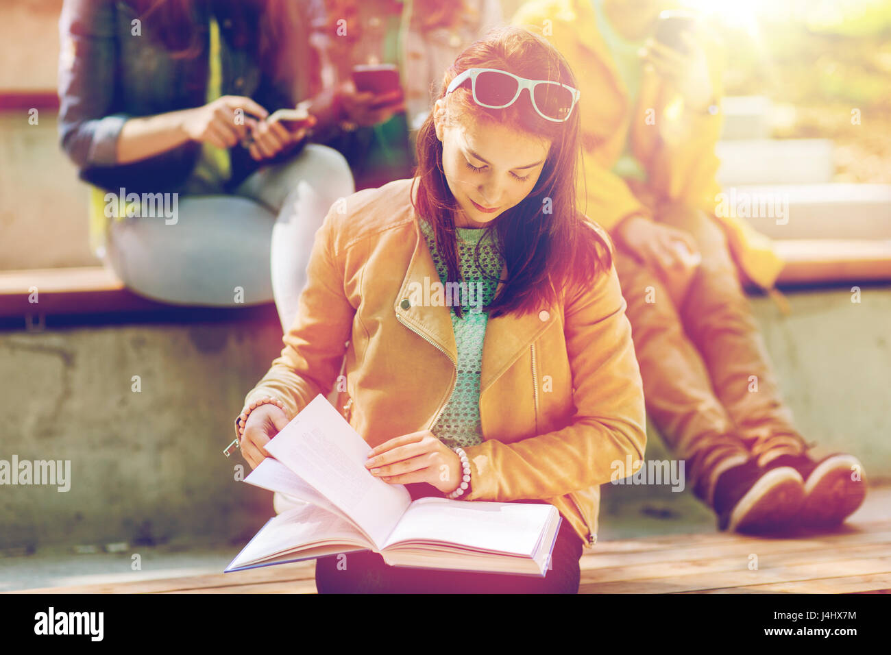 high school student girl reading book outdoors Stock Photo - Alamy