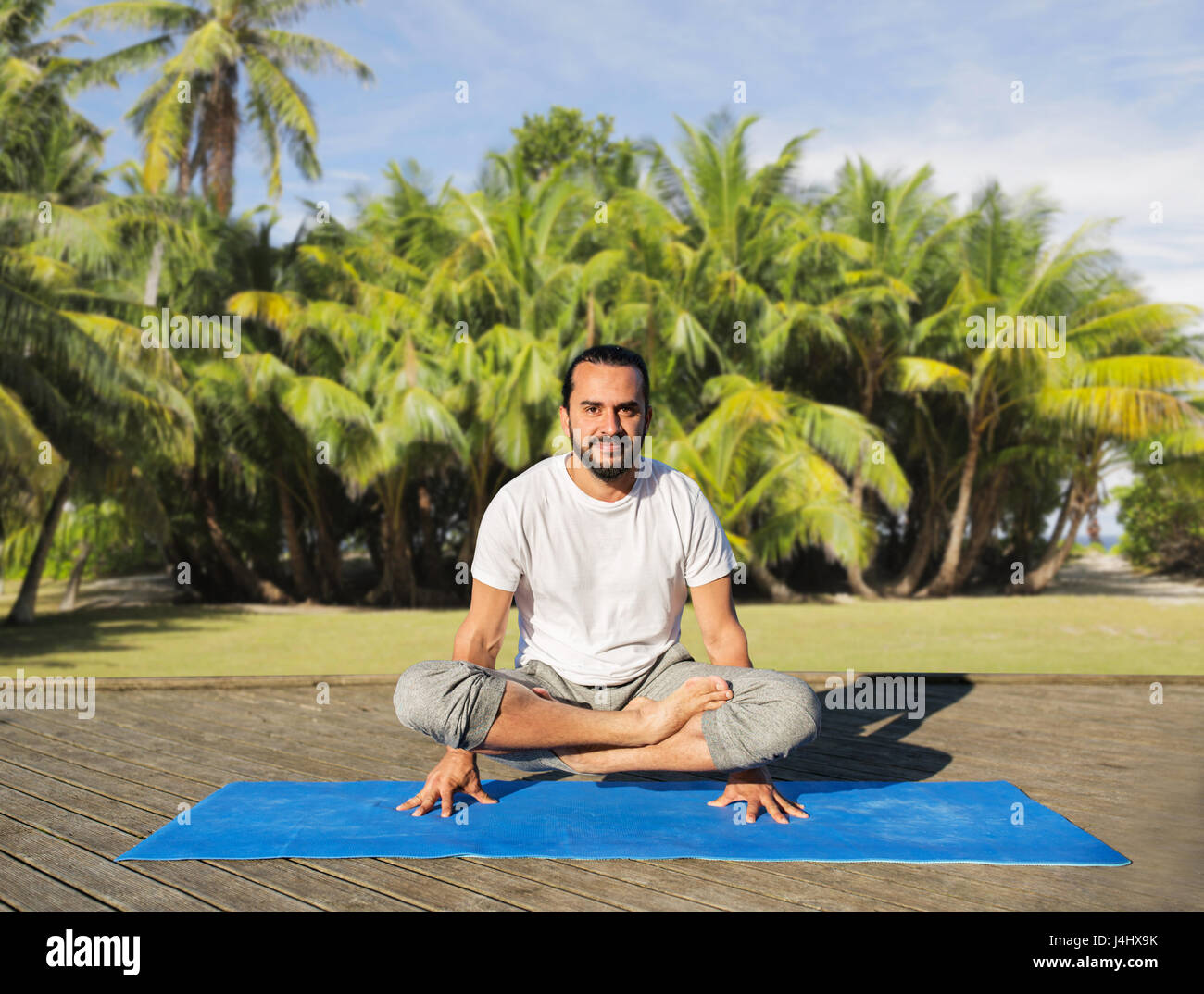 man making yoga in scale pose outdoors Stock Photo - Alamy