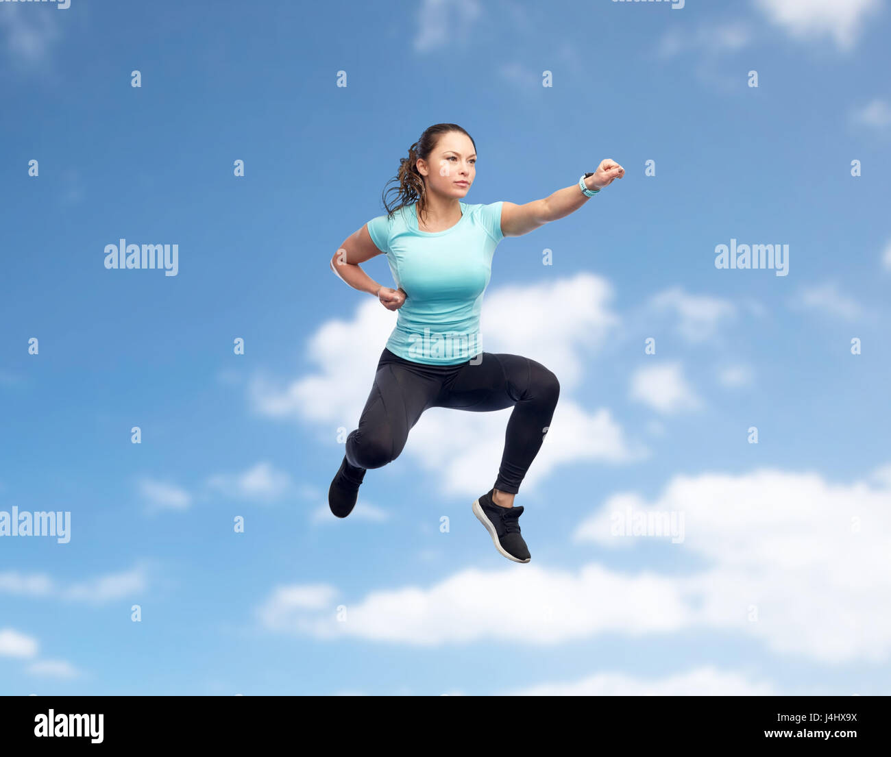 happy sporty young woman jumping in fighting pose Stock Photo - Alamy