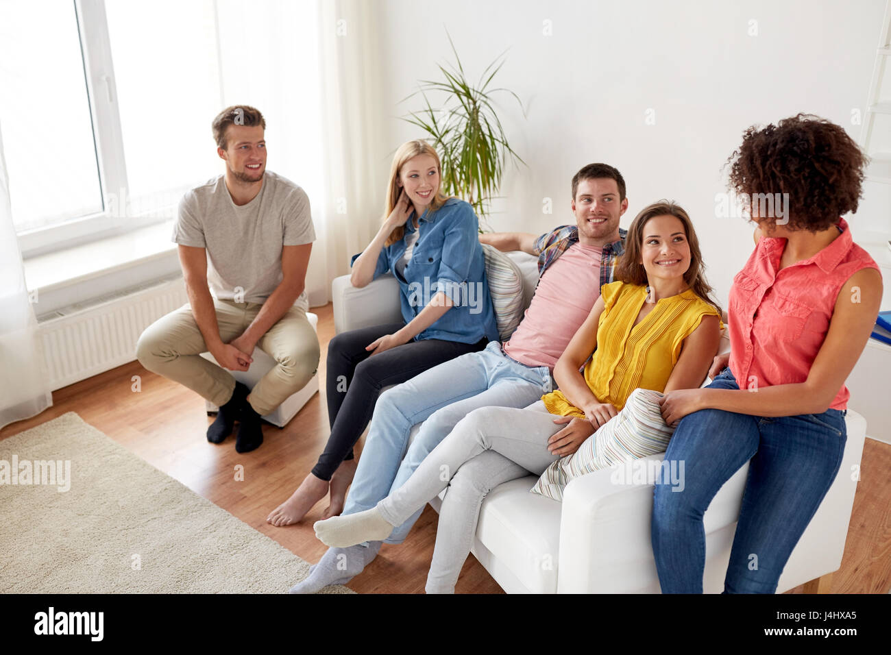 group of happy friends talking at home Stock Photo - Alamy