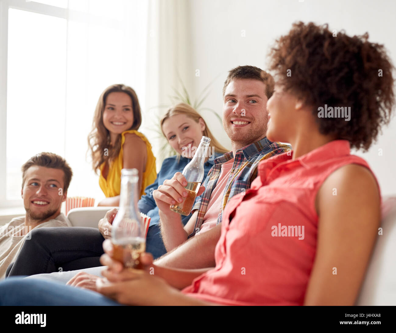 happy friends with popcorn and beer at home Stock Photo - Alamy