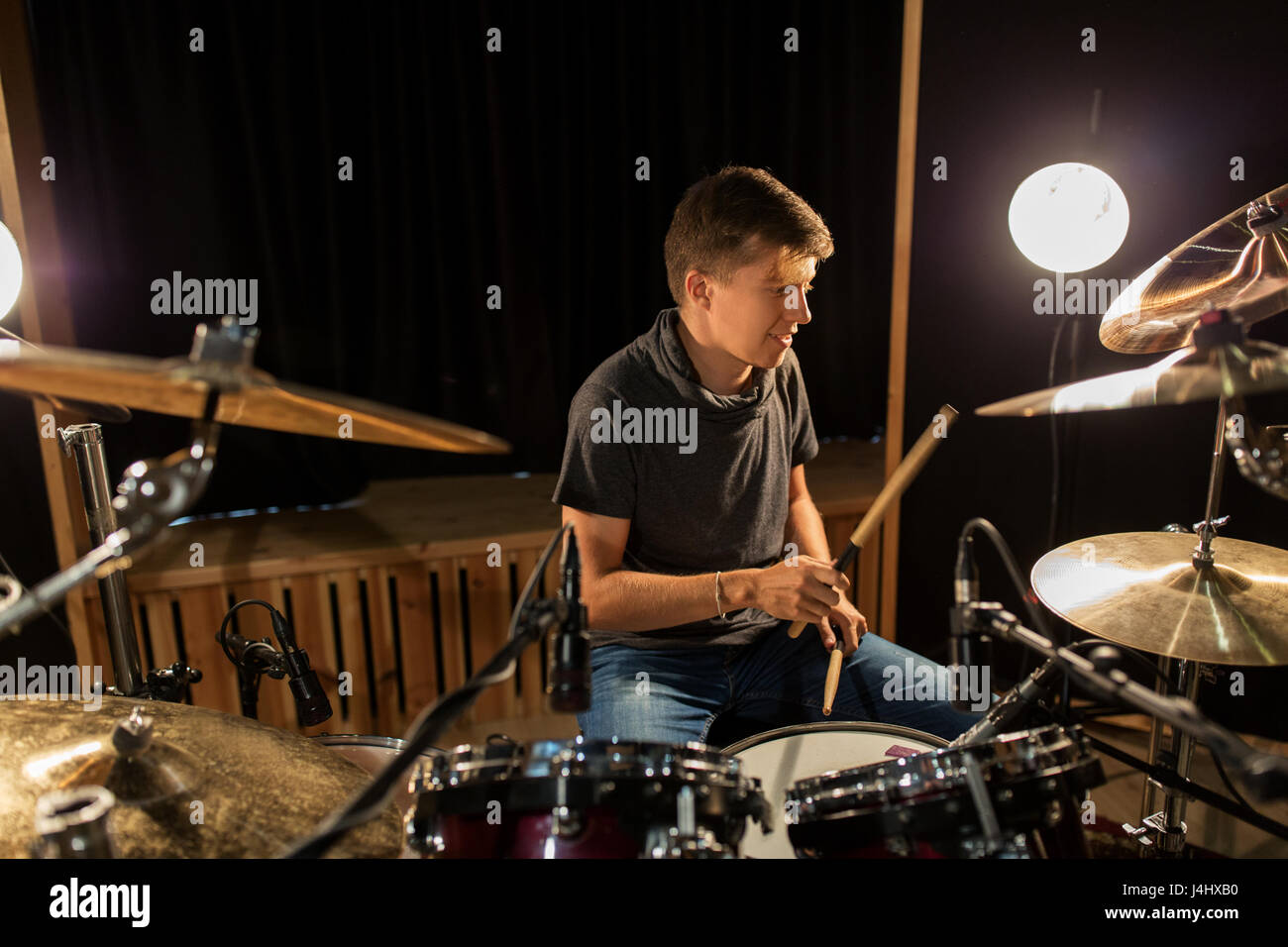 male musician playing drums and cymbals at concert Stock Photo - Alamy