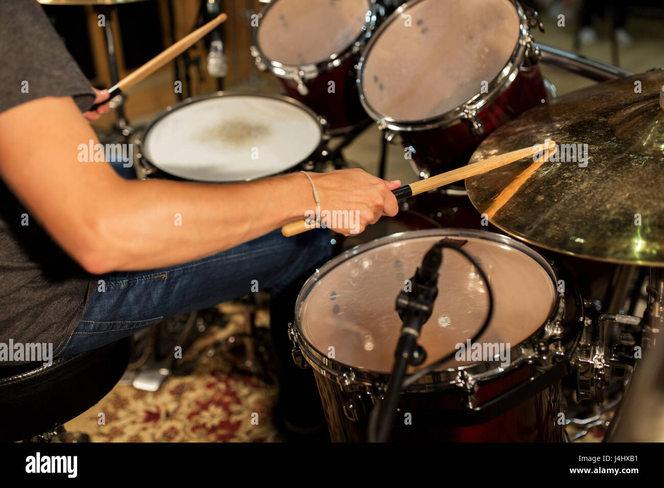 male musician playing drums and cymbals at concert Stock Photo - Alamy