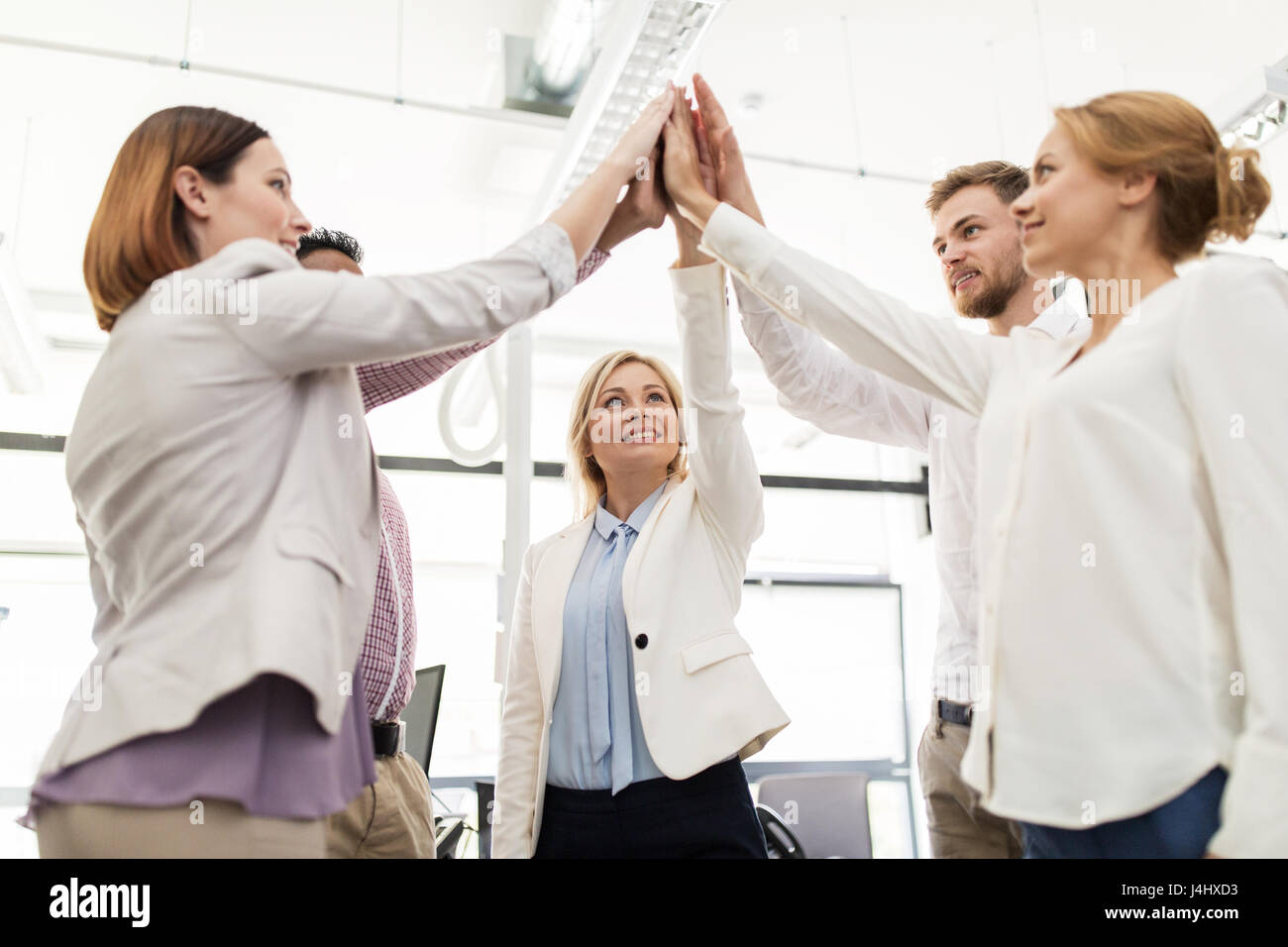happy business team making high five at office Stock Photo - Alamy