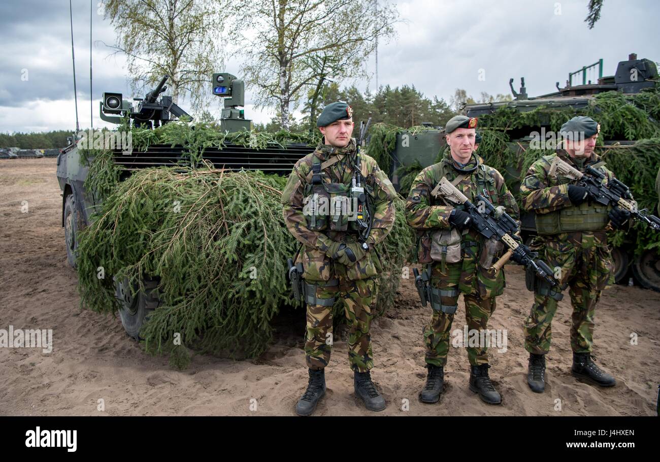 British soldiers in full battle uniform stand for review during a NATO ...