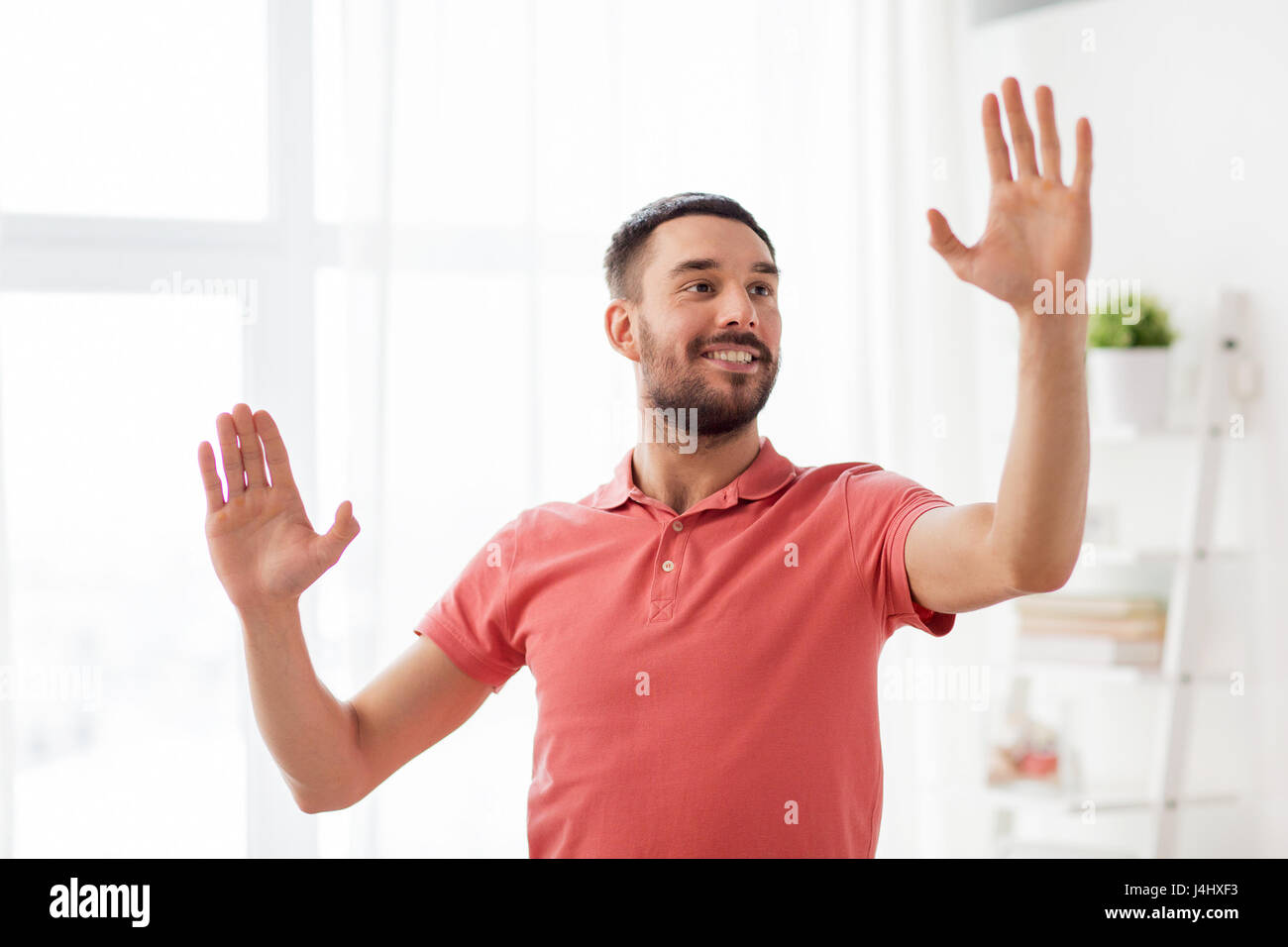 happy man touching something imaginary at home Stock Photo - Alamy