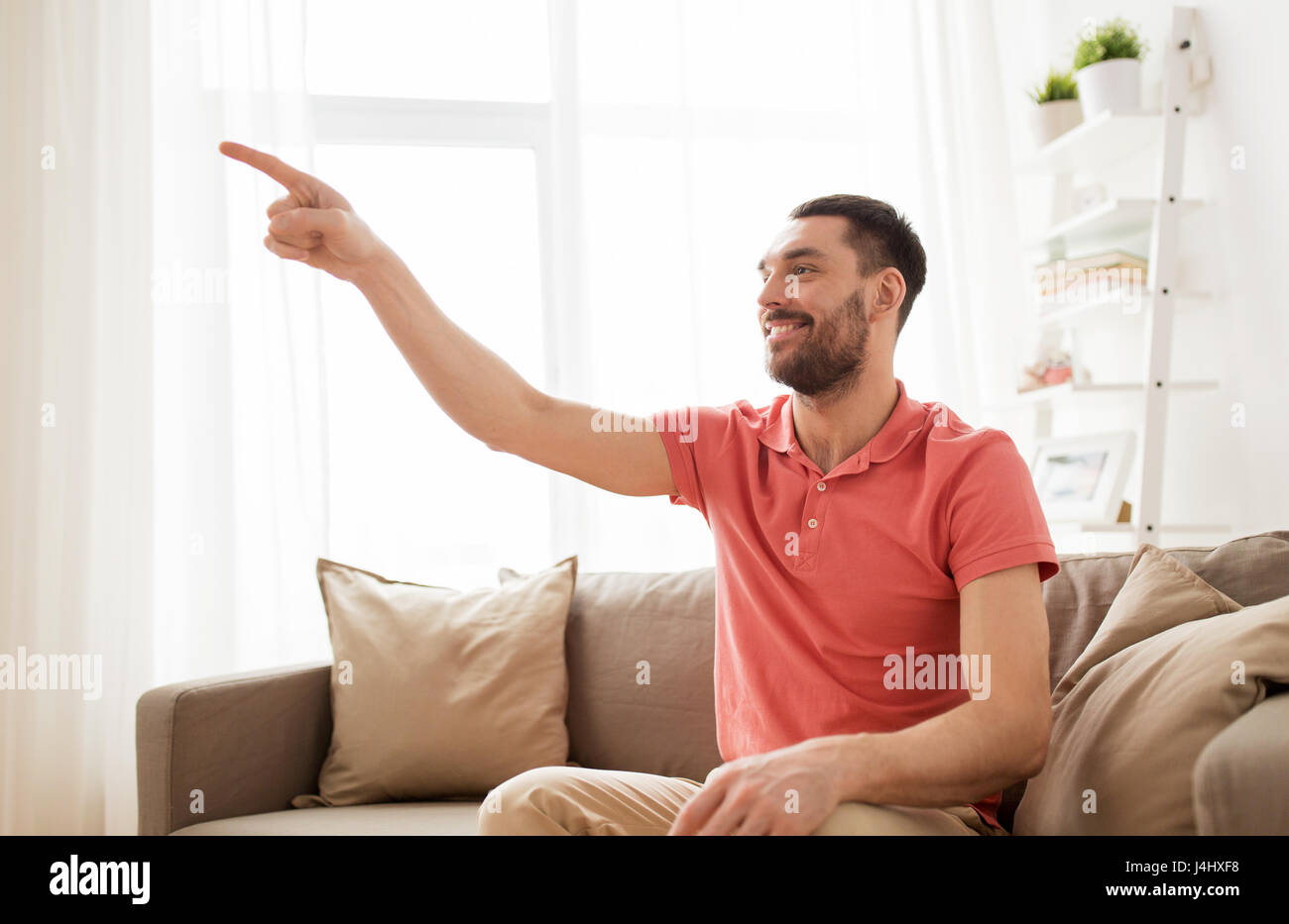 happy man touching something imaginary at home Stock Photo - Alamy