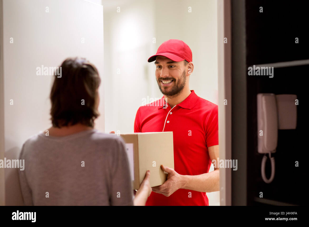 happy delivery man giving parcel box to customer Stock Photo - Alamy