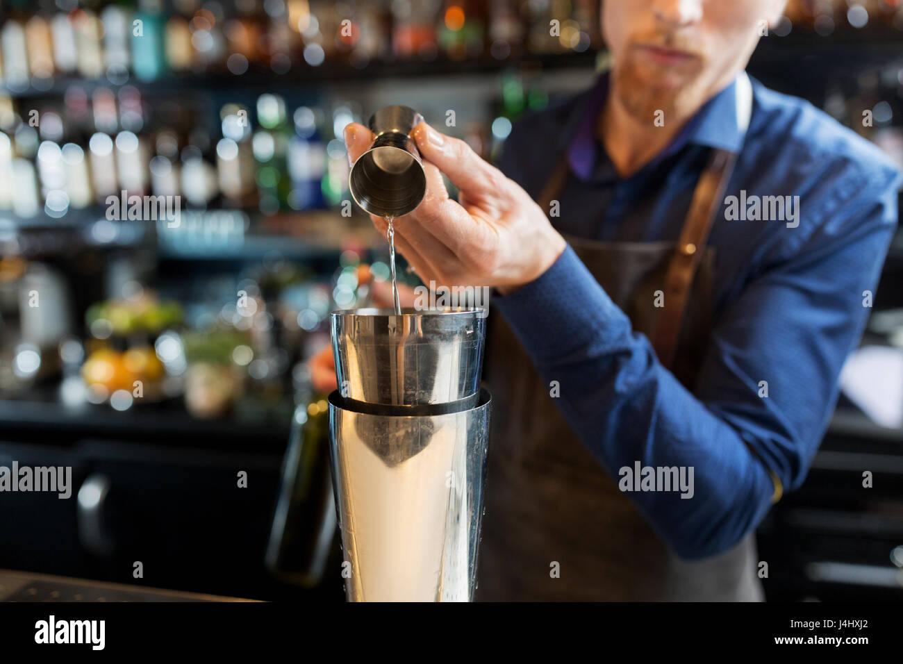 barman with shaker preparing cocktail at bar Stock Photo - Alamy