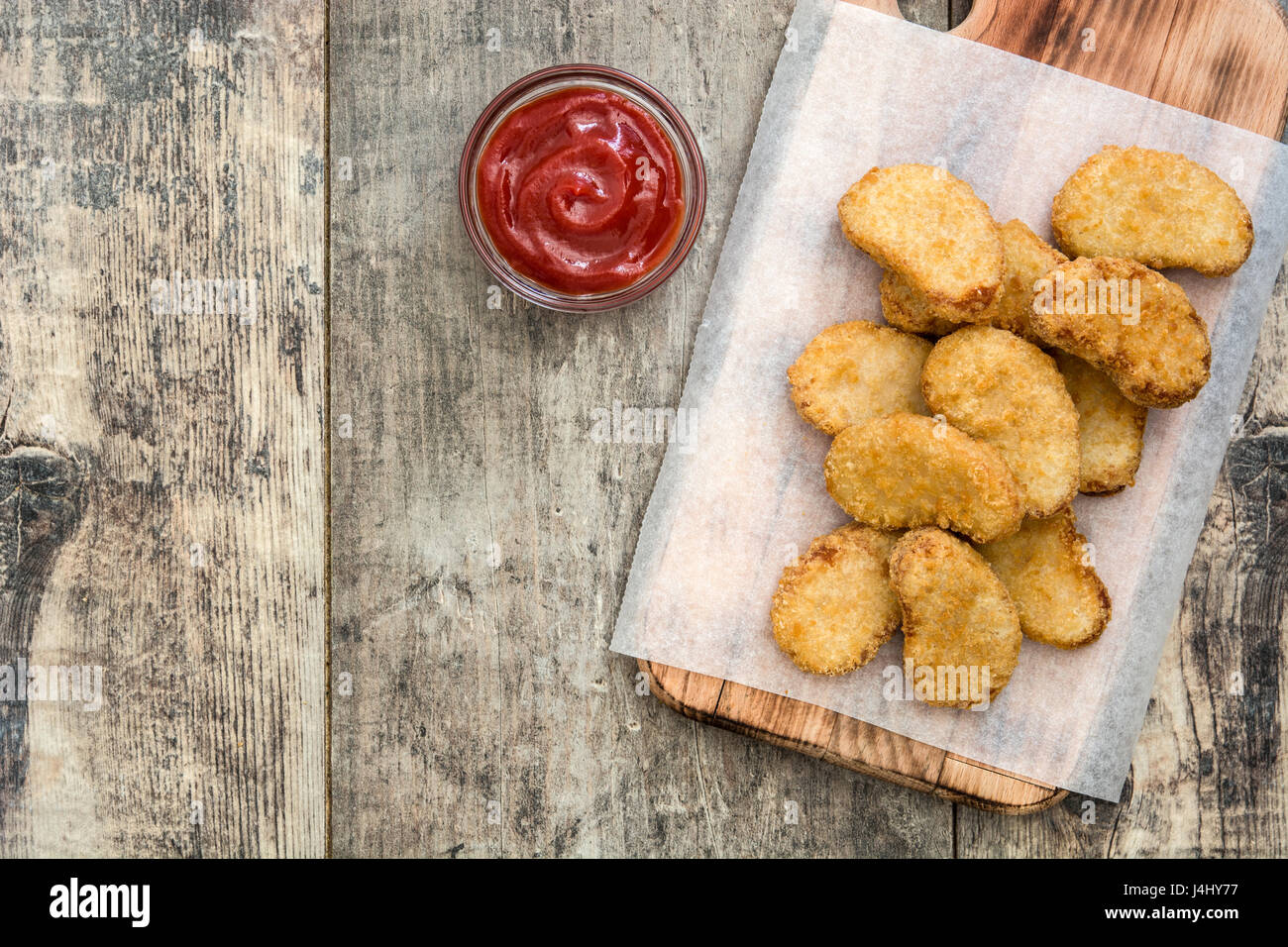 Fried chicken nuggets on wooden table Stock Photo - Alamy
