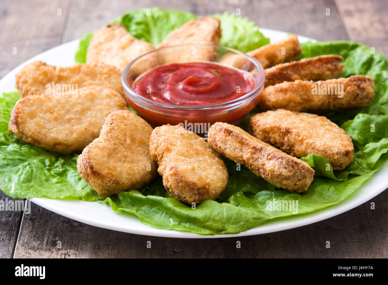 Fried chicken nuggets on wooden table Stock Photo - Alamy
