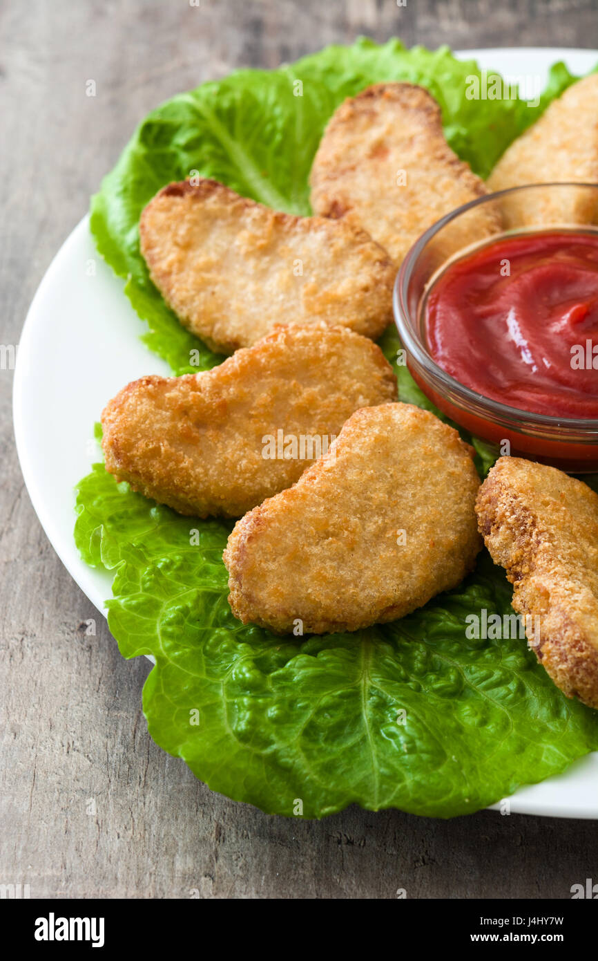Fried chicken nuggets on wooden table Stock Photo - Alamy