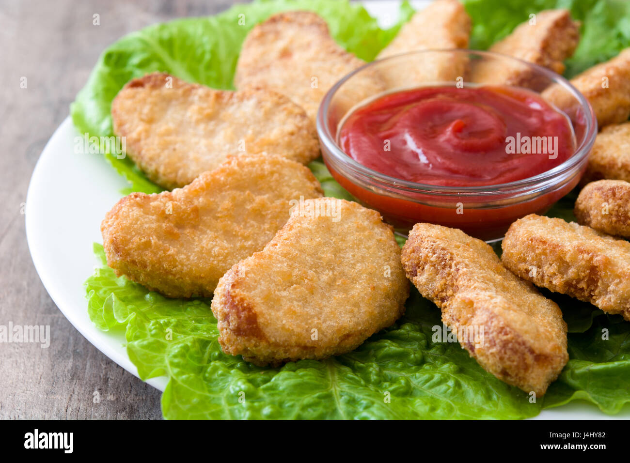 Fried chicken nuggets on wooden table Stock Photo - Alamy