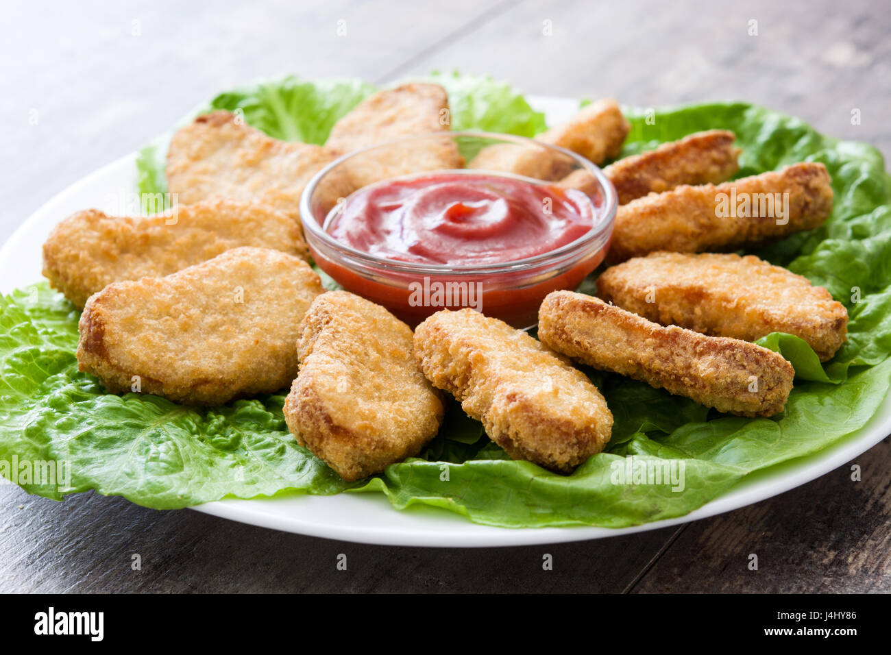 Fried chicken nuggets on wooden table Stock Photo - Alamy