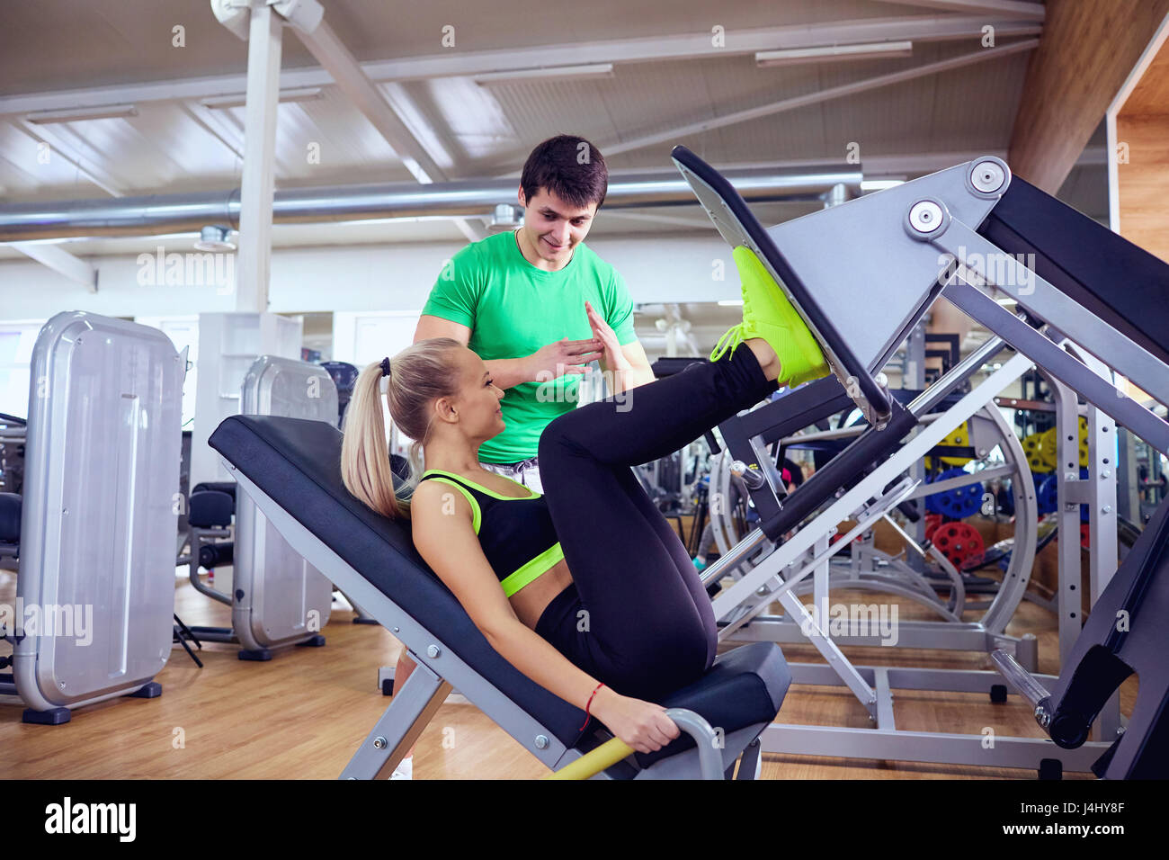 A girl is doing exercises on the foot simulator with personal t Stock ...