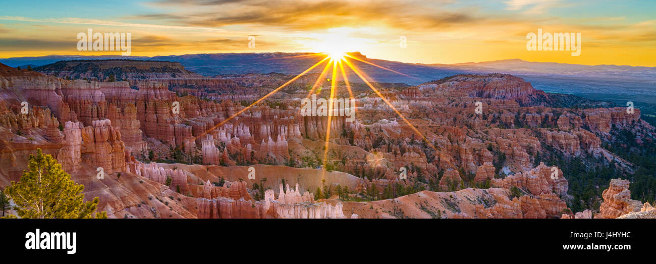 Sun rising above the horizon with sun rays at Bryce Canyon national ...