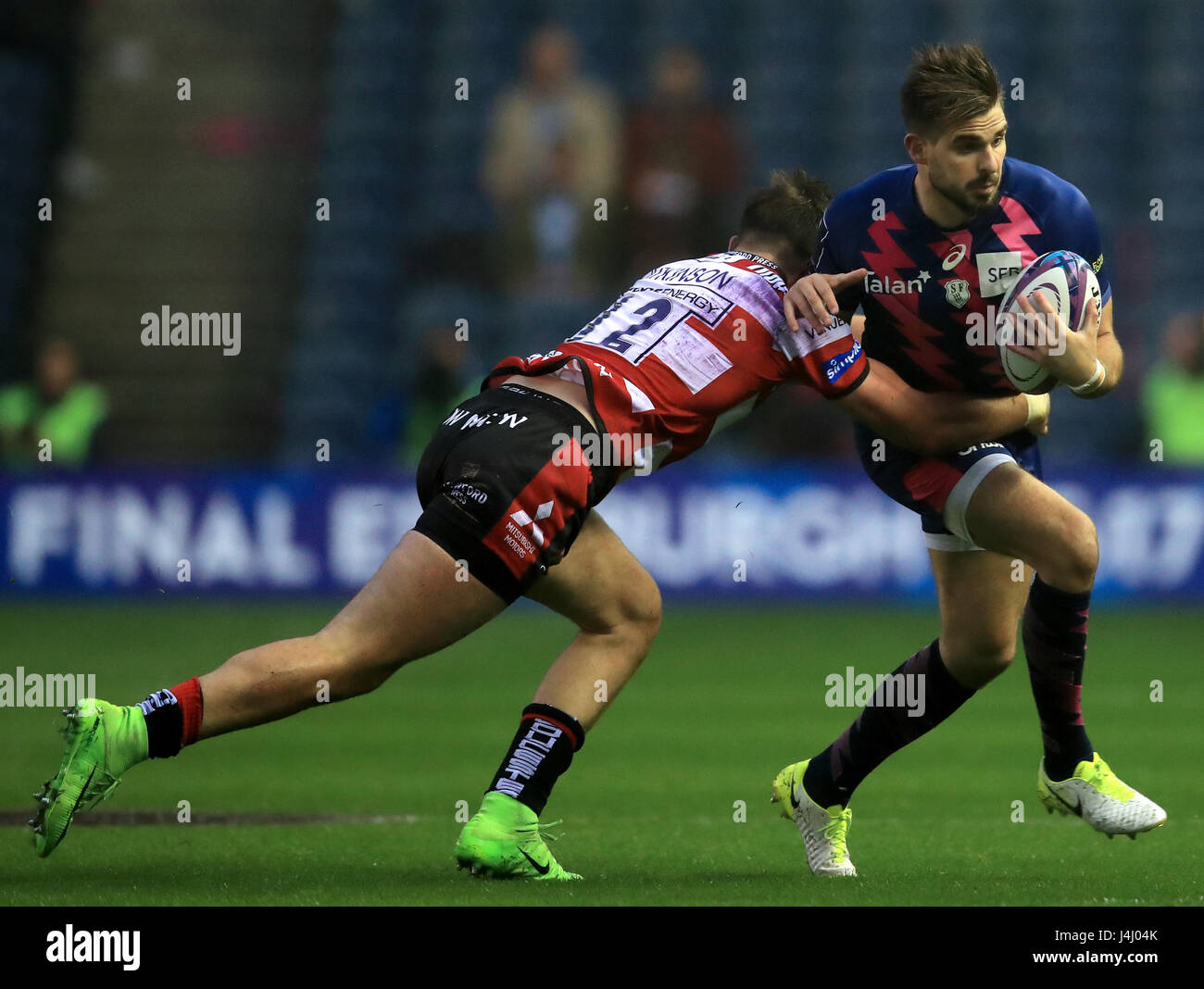 Gloucester Rugby's Mark Atkinson (left) tackles Stade Francais' Hugo ...