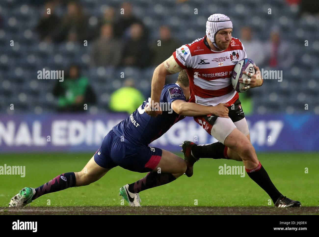 Stade Francais' Jules Plisson (left) tackles Gloucester Rugby's Ben ...
